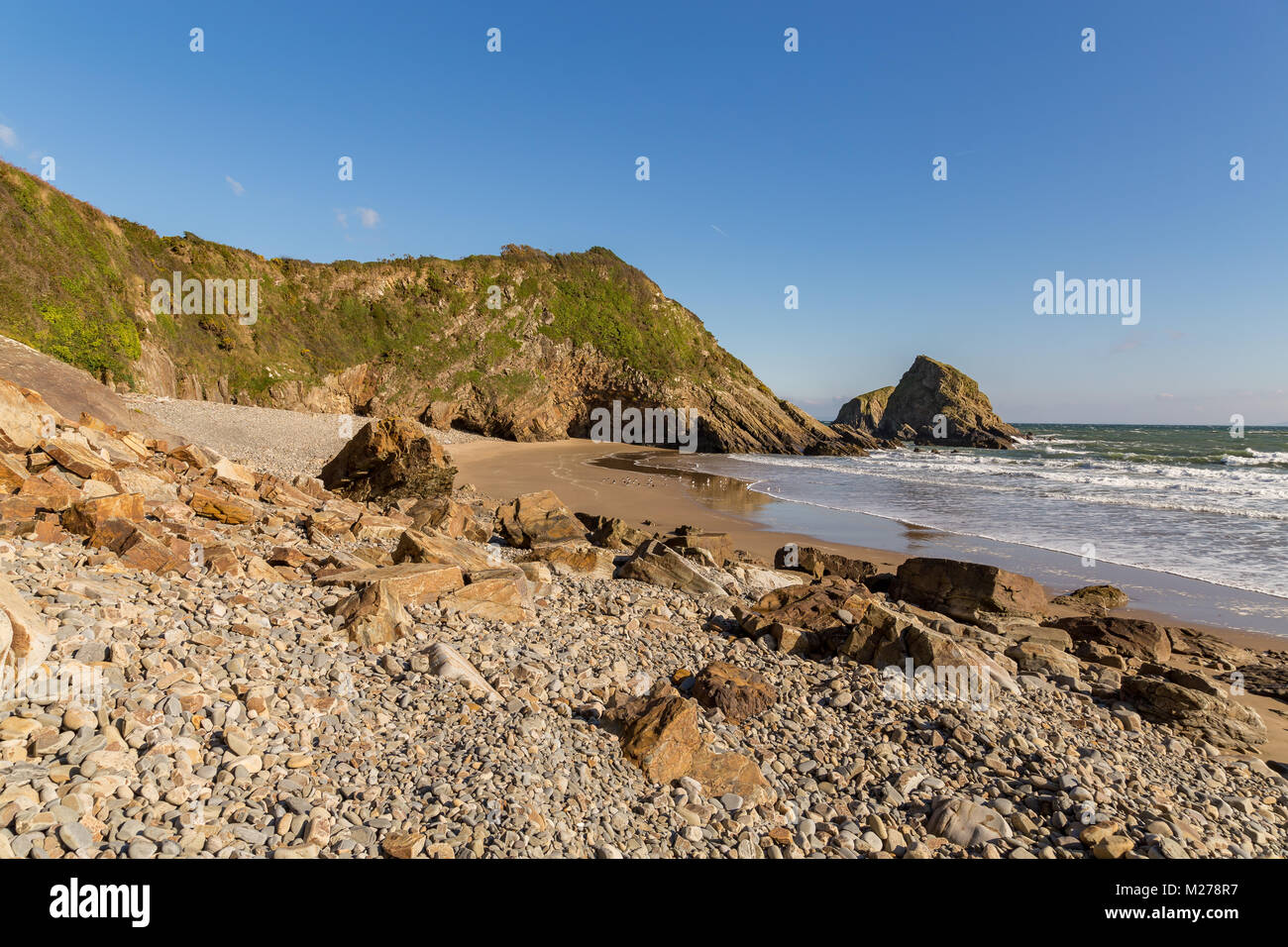 Pebble beach and cliffs at Monkstone Beach near Saundersfoot in ...