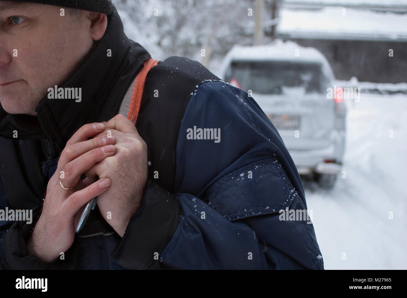 Man towing a car trapped in snow with rope, outside cropped shot Stock ...