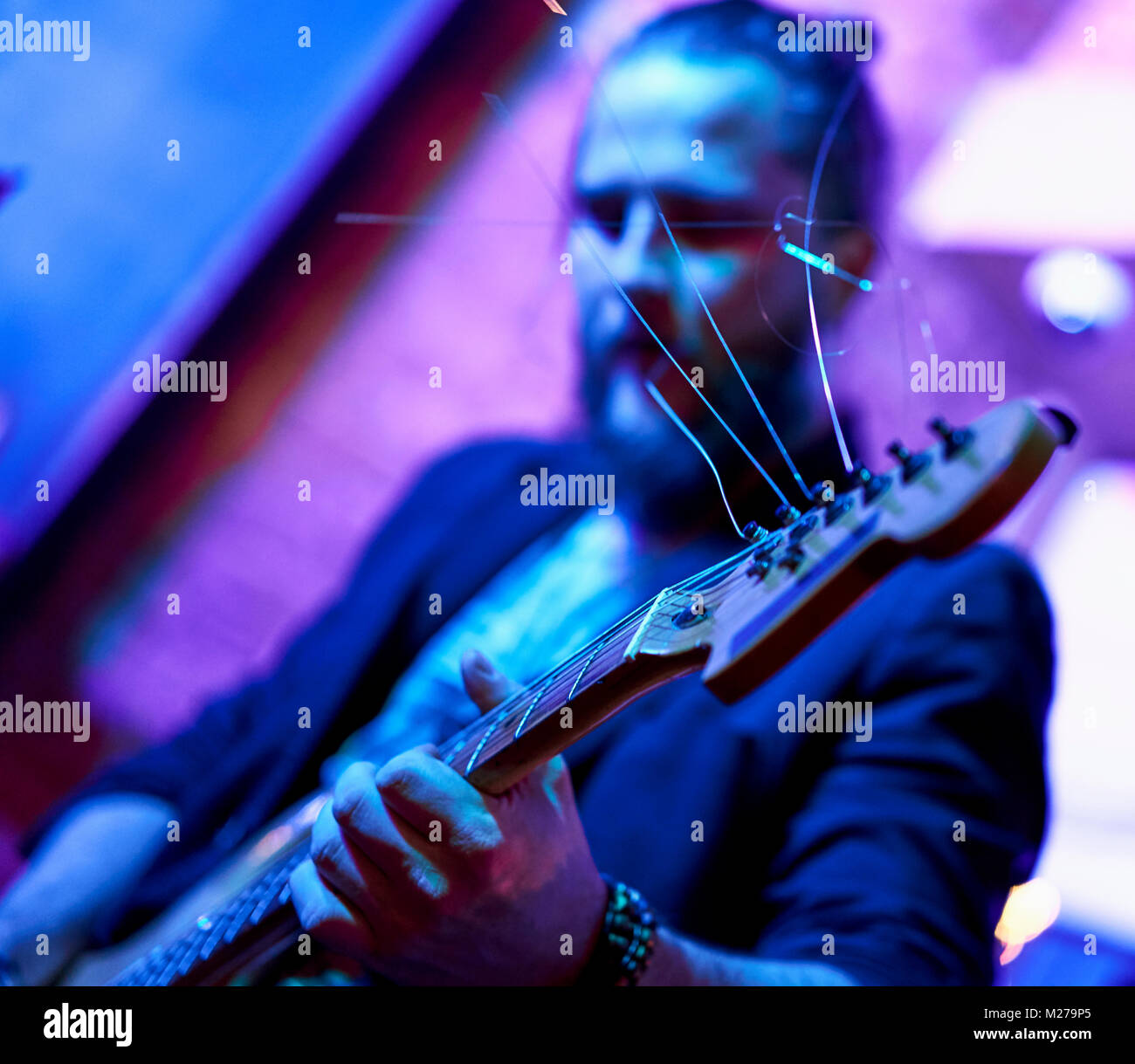 musician plays guitar in the club Stock Photo - Alamy