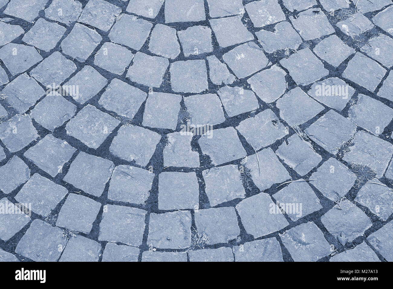 blue cobblestone road. a stone road in the city. stone road surface ...