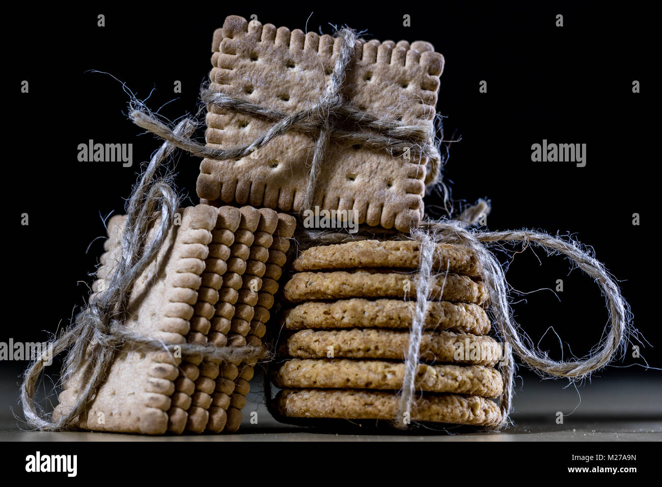 Cookies tied with a gray jute string into a bow. Cookies of sweets on a ...