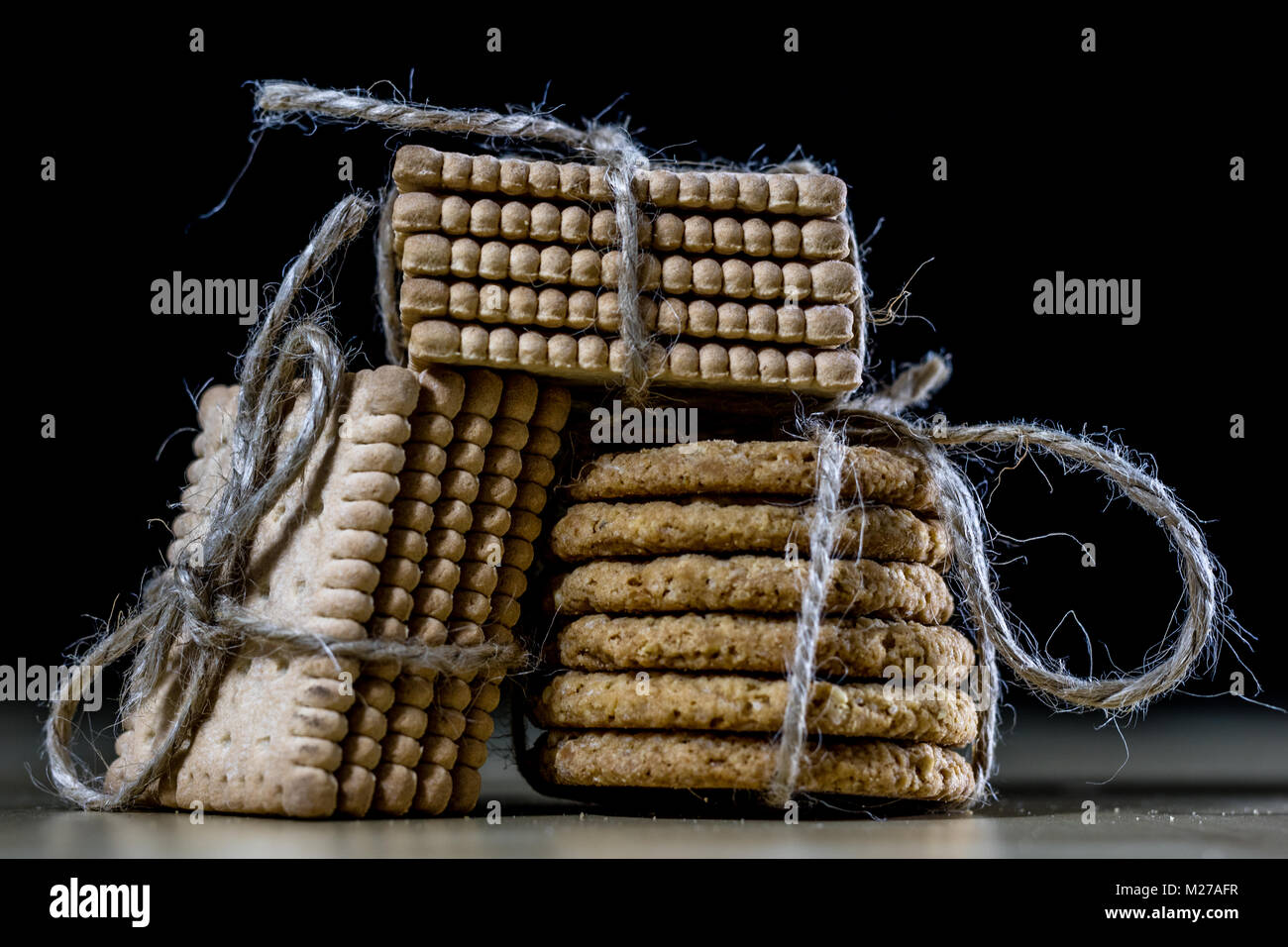 Cookies tied with a gray jute string into a bow. Cookies of sweets on a ...