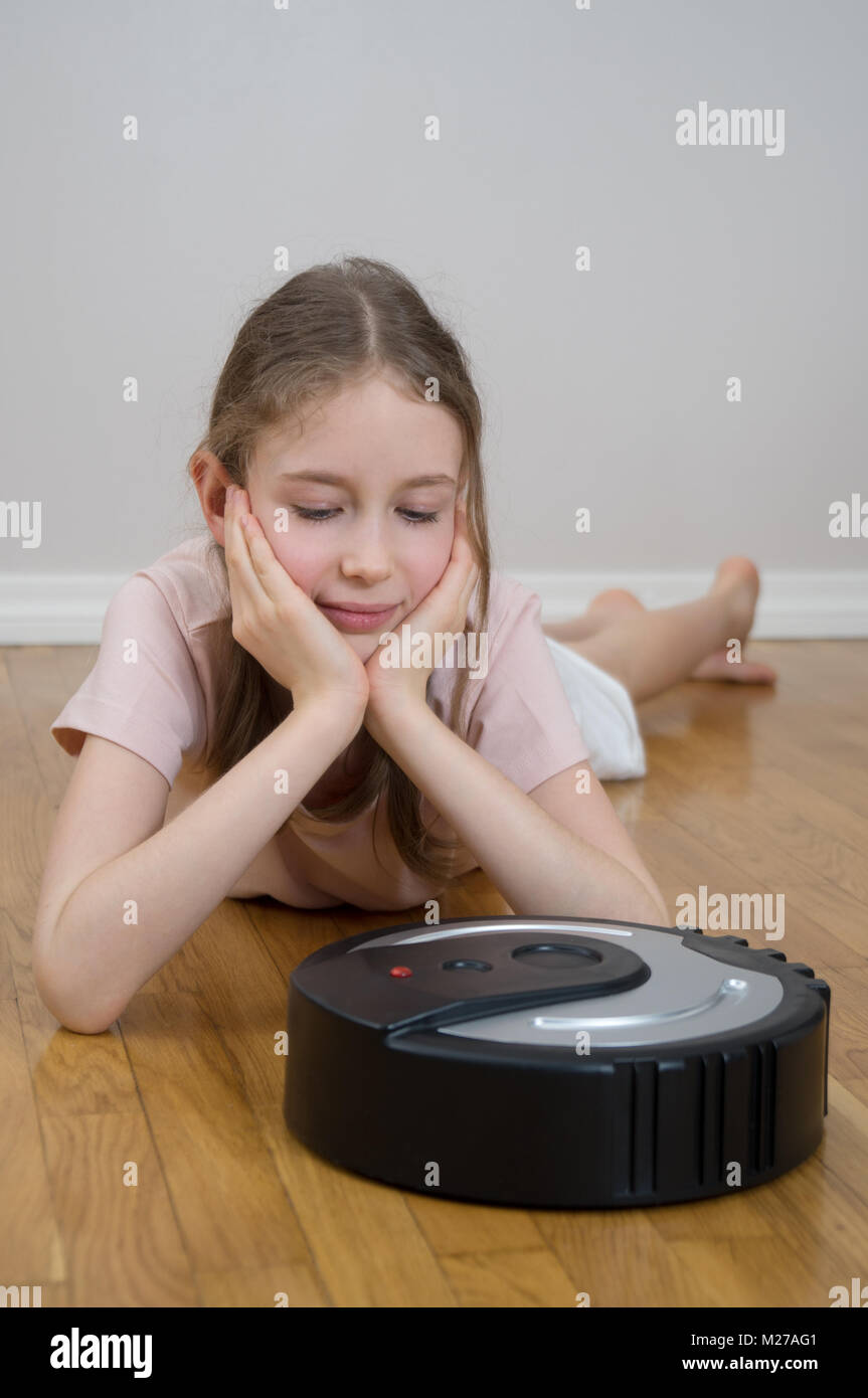 Little girl and robotic vacuum cleaner on the floor Stock Photo - Alamy