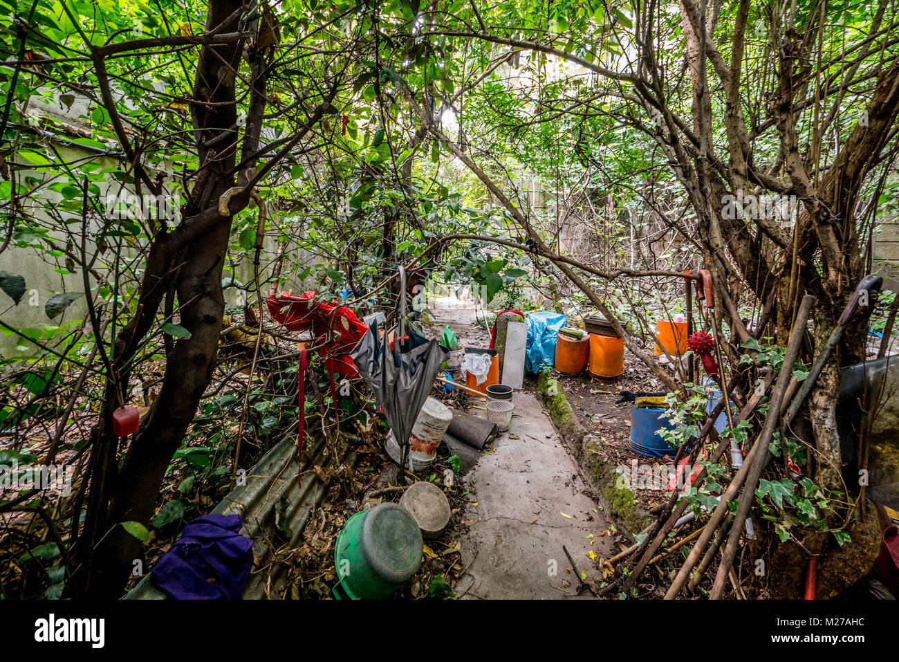 garden in decay with garbage, urban exploration Stock Photo - Alamy
