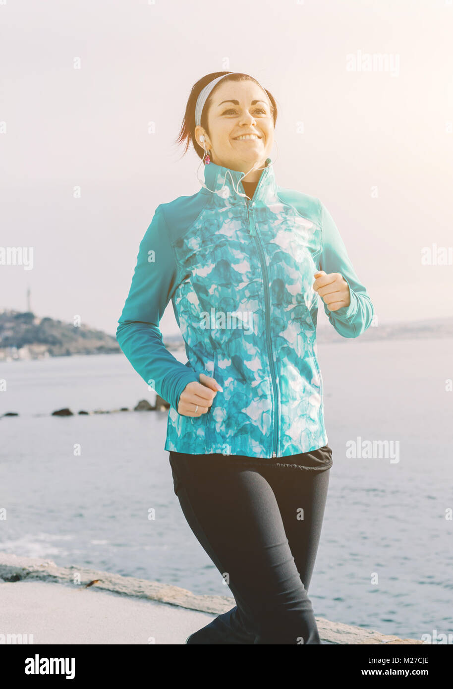 Young fitness woman running at seaside. Concept Fitness and Healthy ...