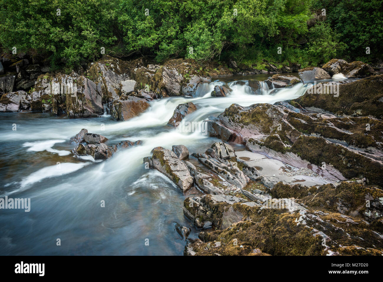 River flowing over rocks with blurred water Stock Photo - Alamy