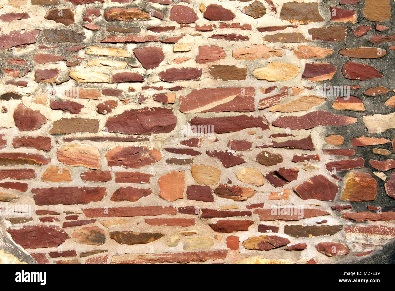 Ancient wall of stone blocks of red color Stock Photo - Alamy