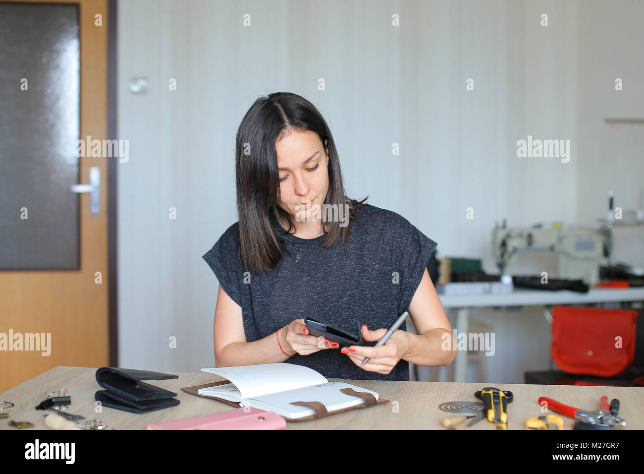 Young woman making bag at sewing circle Stock Photo - Alamy