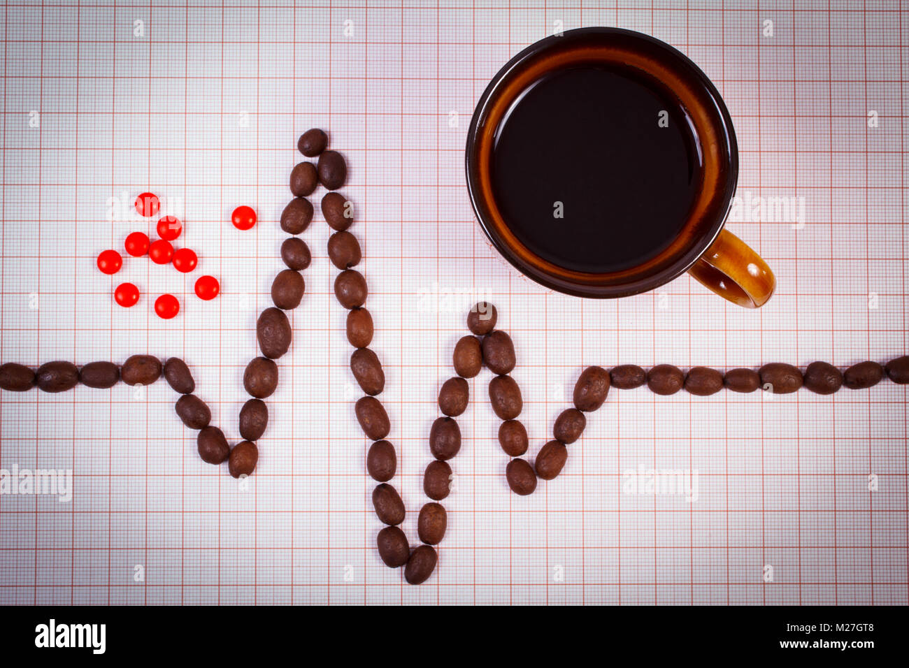 Electrocardiogram line of roasted coffee grains, cup of hot coffee and ...