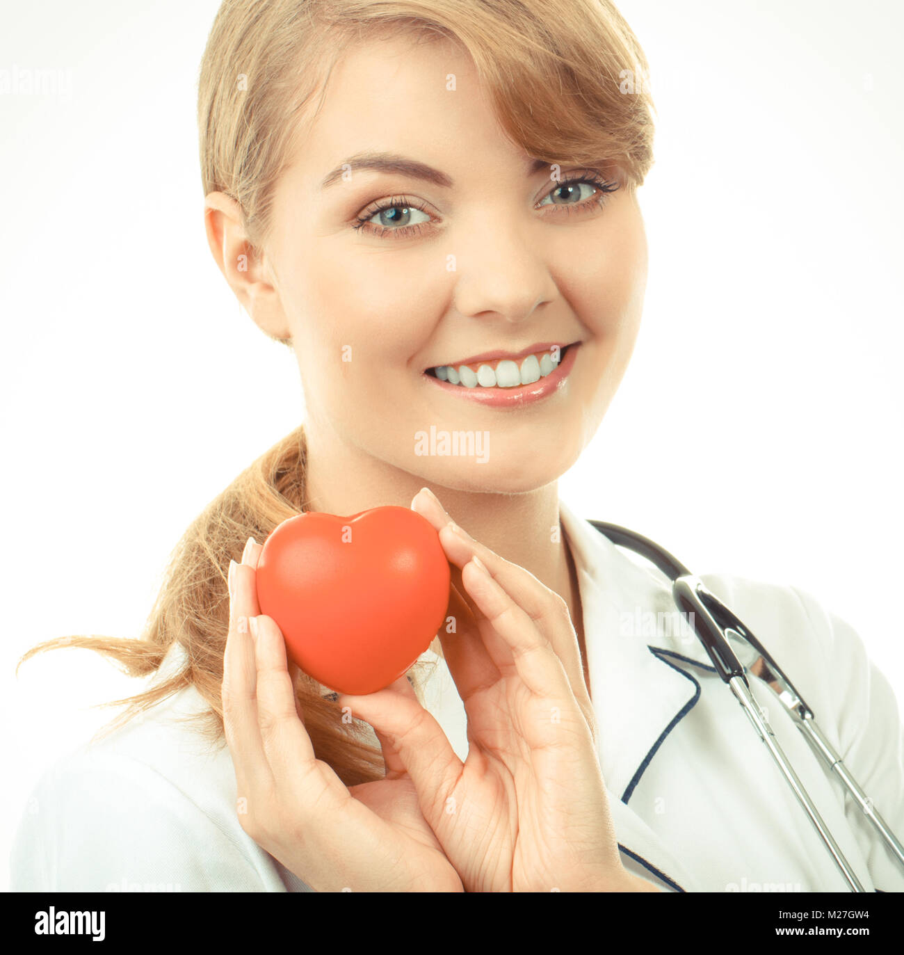 Smiling woman doctor cardiologist in white apron with stethoscope ...