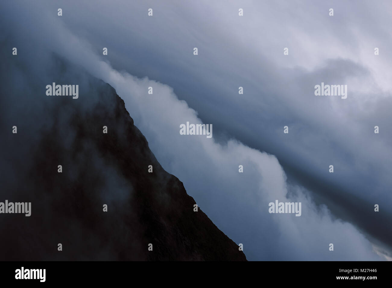 Mist settling over a mountain Stock Photo - Alamy