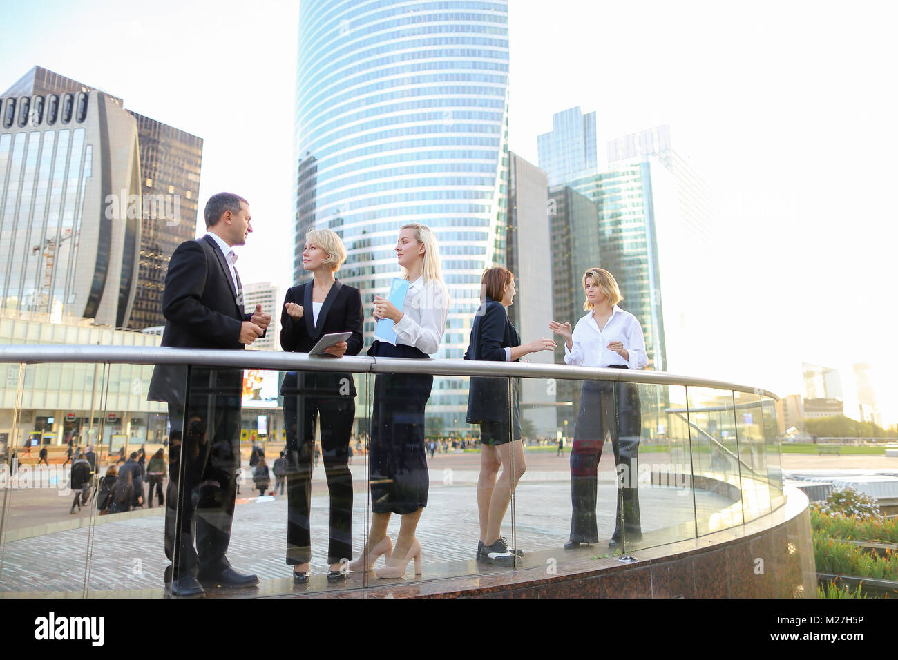 Happy business team members talking outside in Stock Photo - Alamy