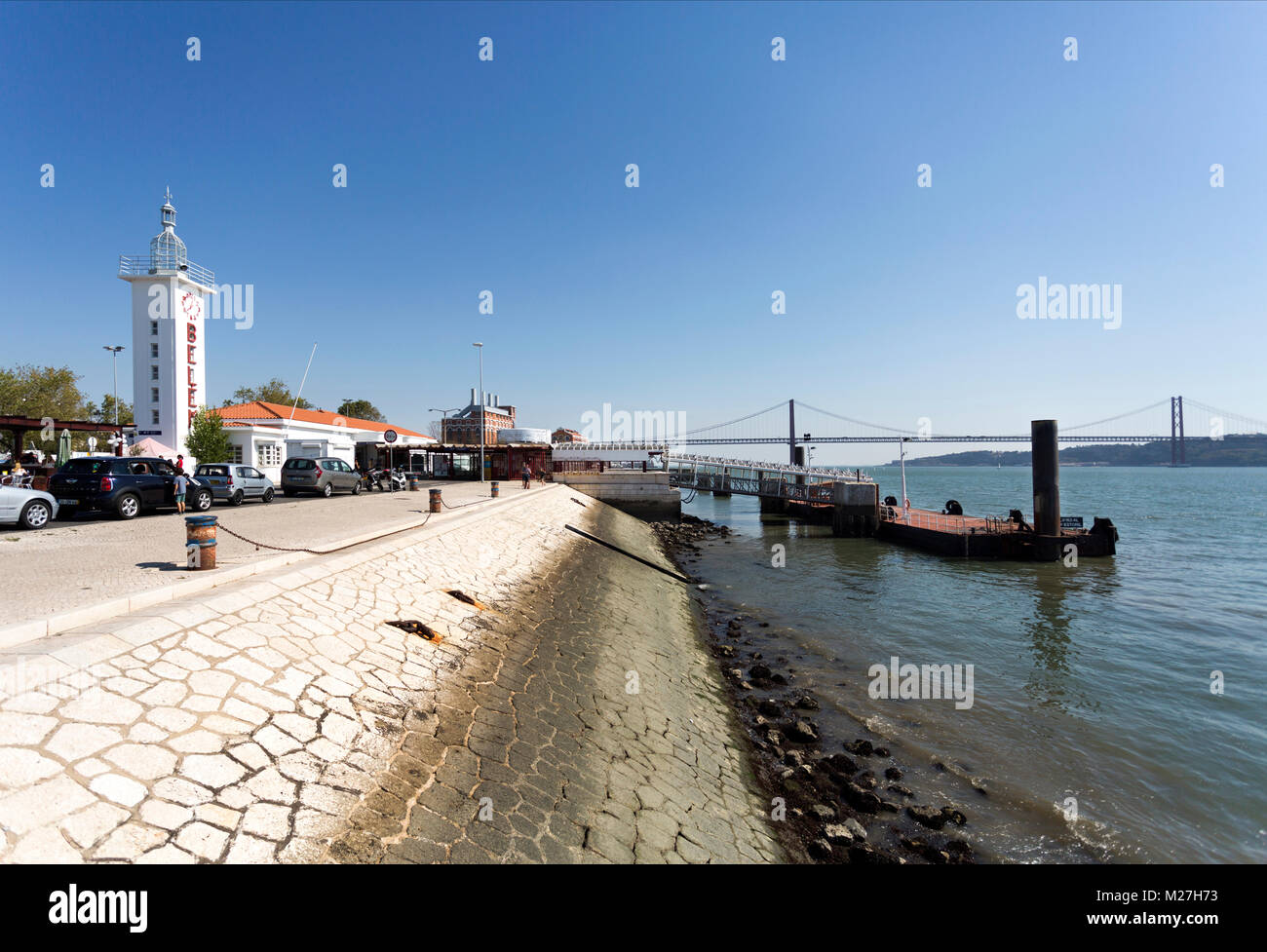 Belem ferry terminal at low tide with the 25 de Abril bridge in the ...