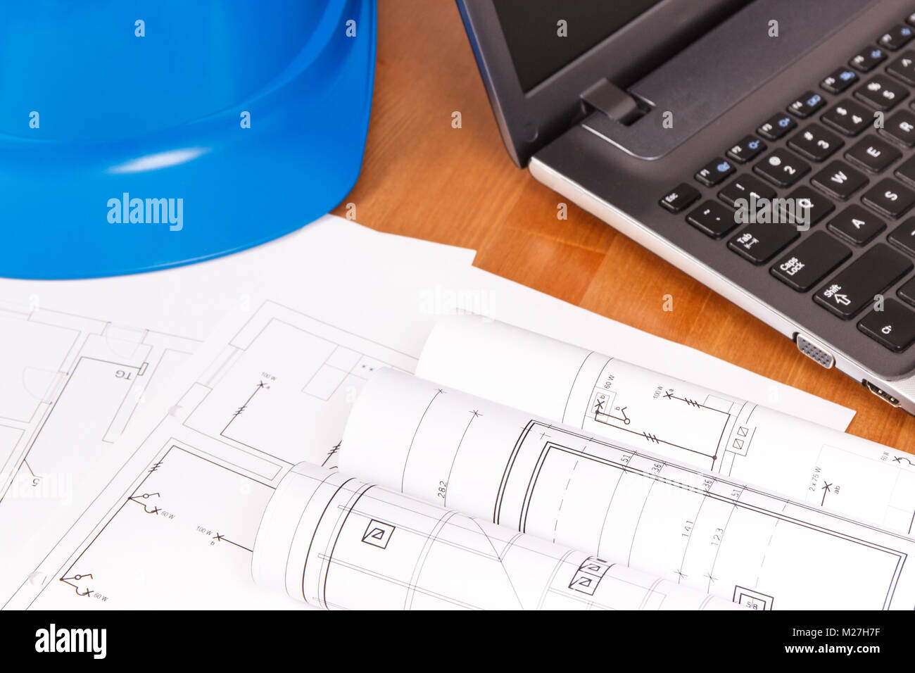Diagrams or electrical construction drawings with laptop and protective ...