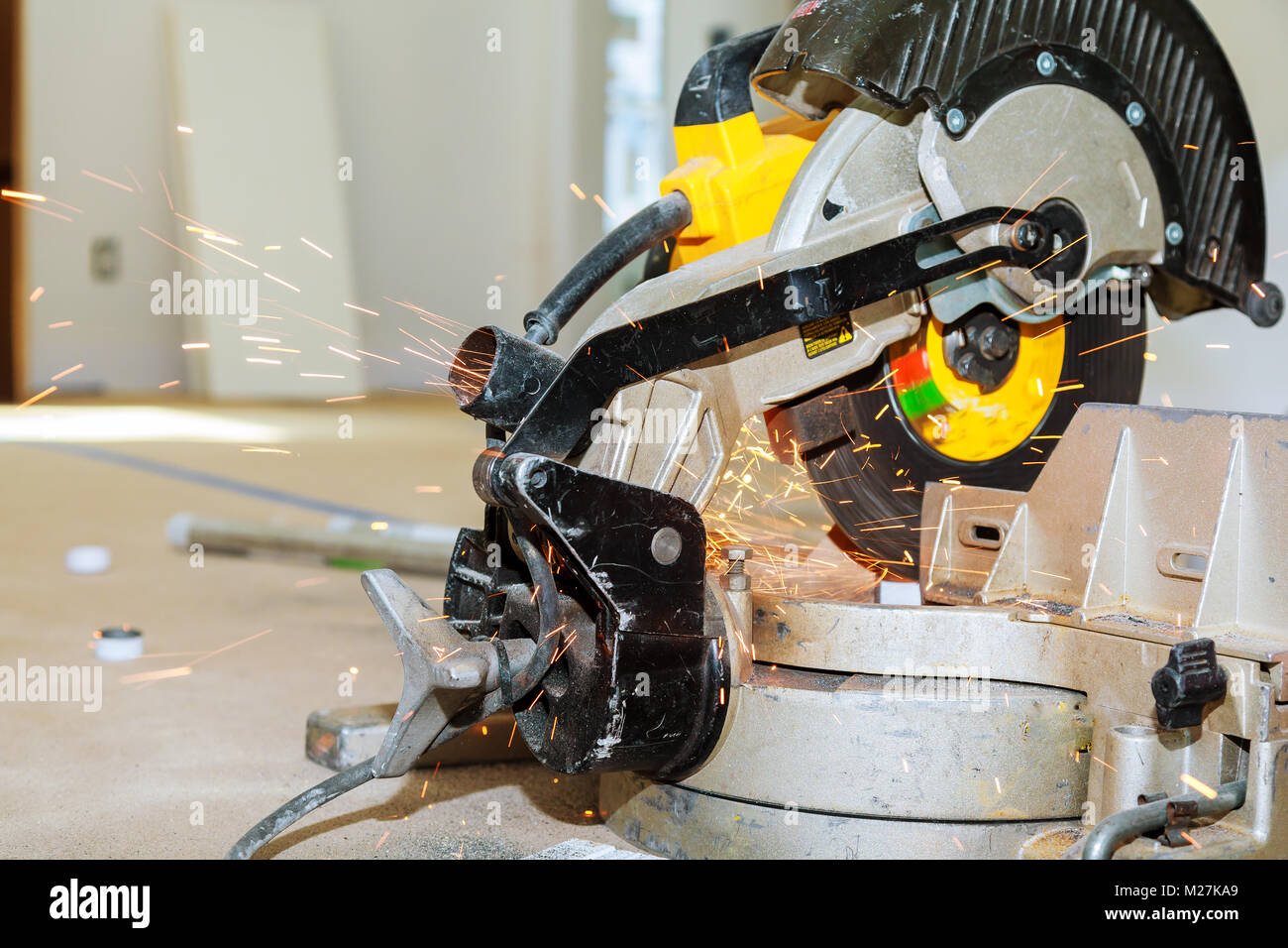 Industrial worker cutting and welding metal with many sharp sparks ...