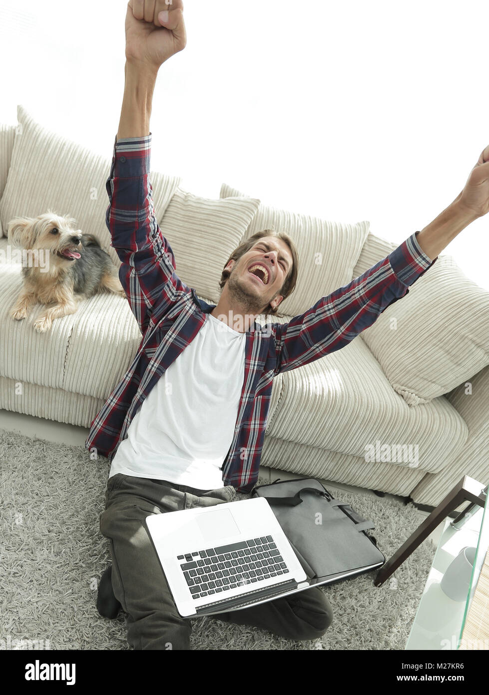 happy guy with laptop jubilant in spacious living room Stock Photo - Alamy