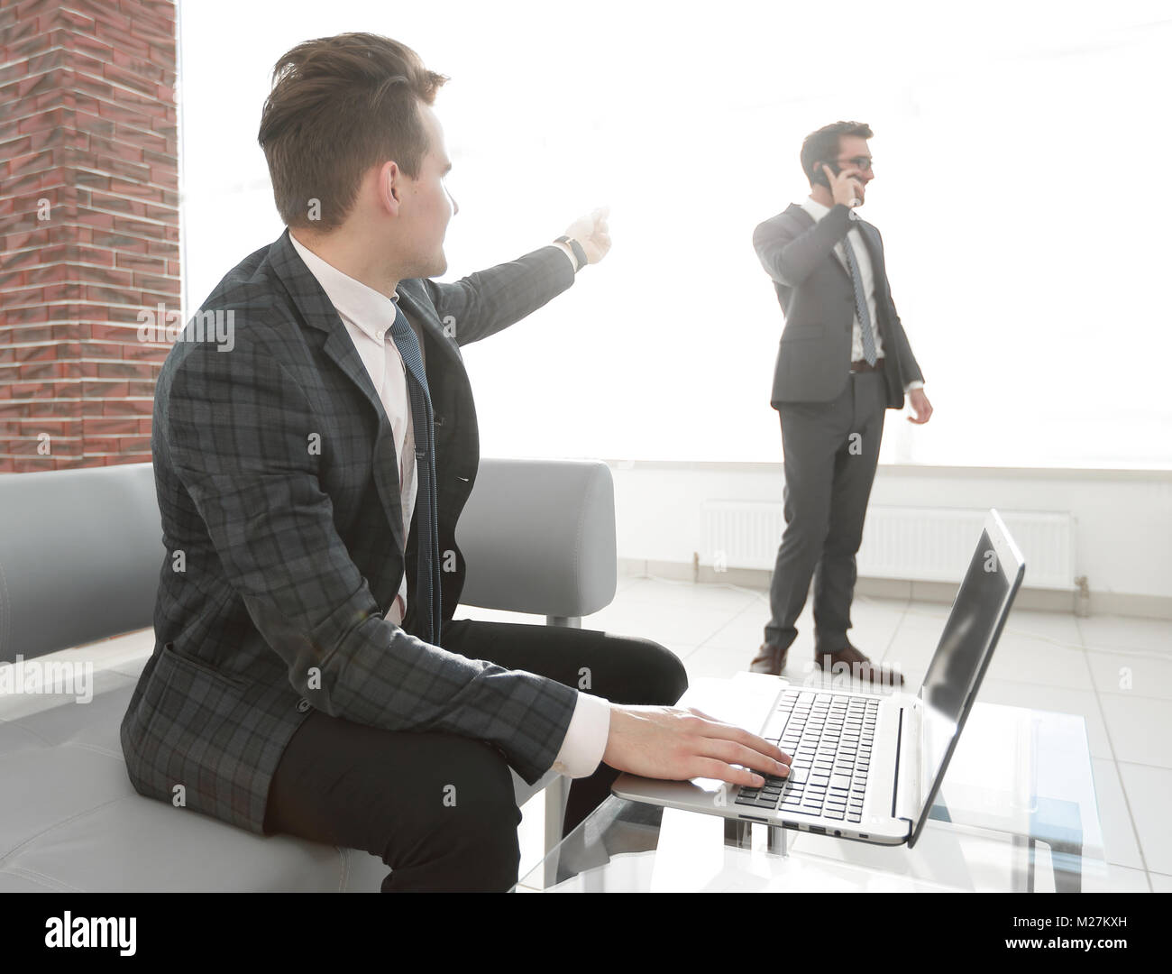 businessman with laptop pointing at the screen Stock Photo - Alamy
