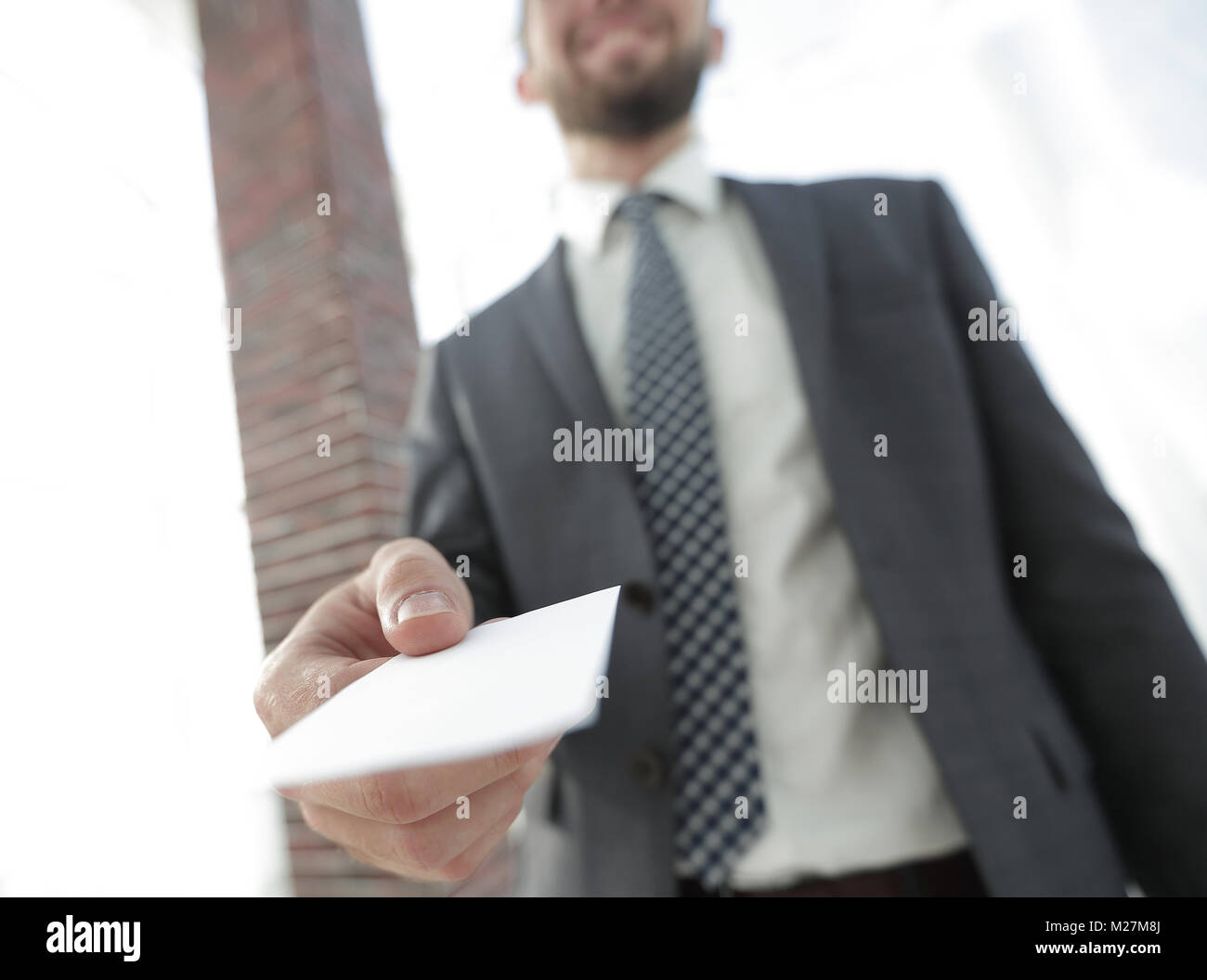 Businessman giving a card. Close-up photo in loft office Stock Photo ...