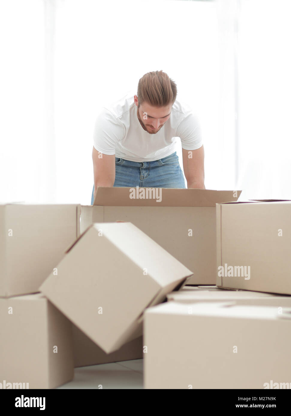 male sorting things in the new apartment Stock Photo - Alamy