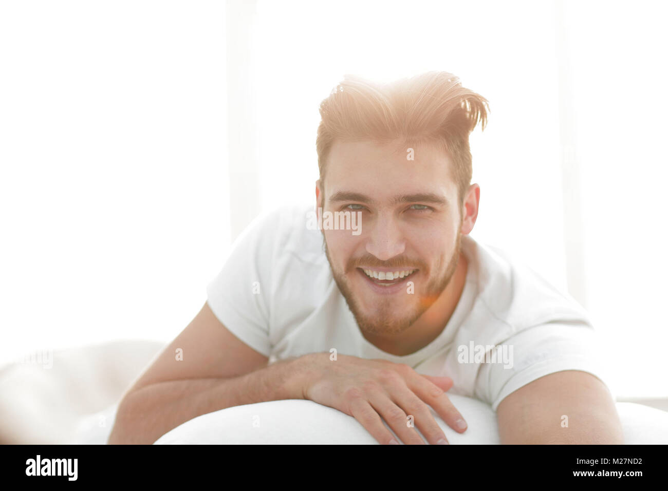closeup.smiling man lying on the sofa Stock Photo - Alamy