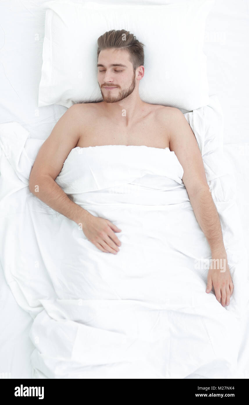 Young man relaxation on the bed top view Stock Photo - Alamy
