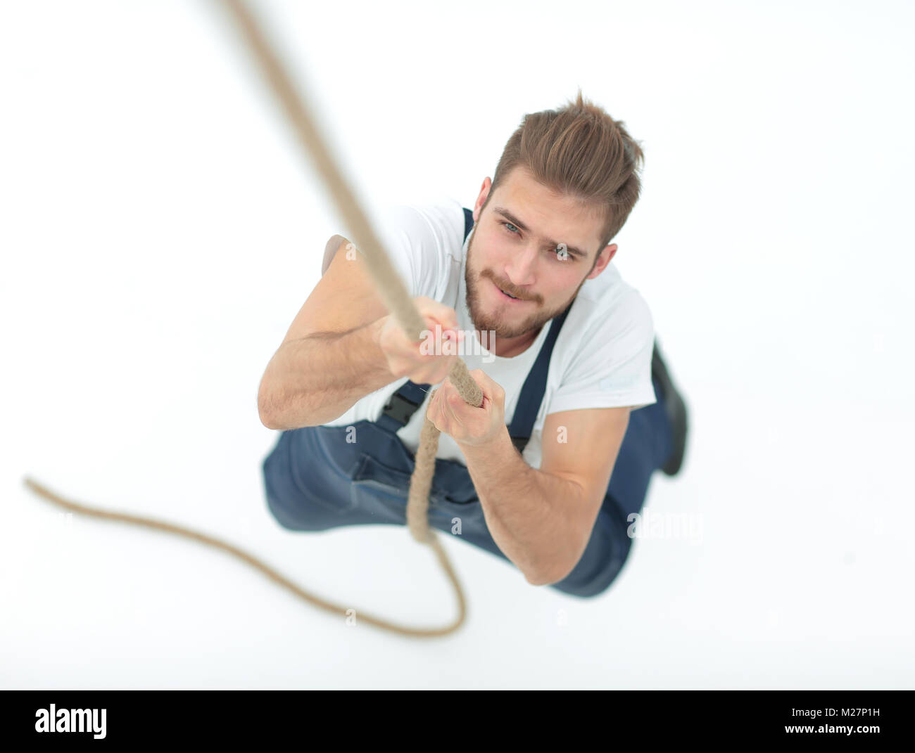 construction worker climbing the rope up Stock Photo - Alamy