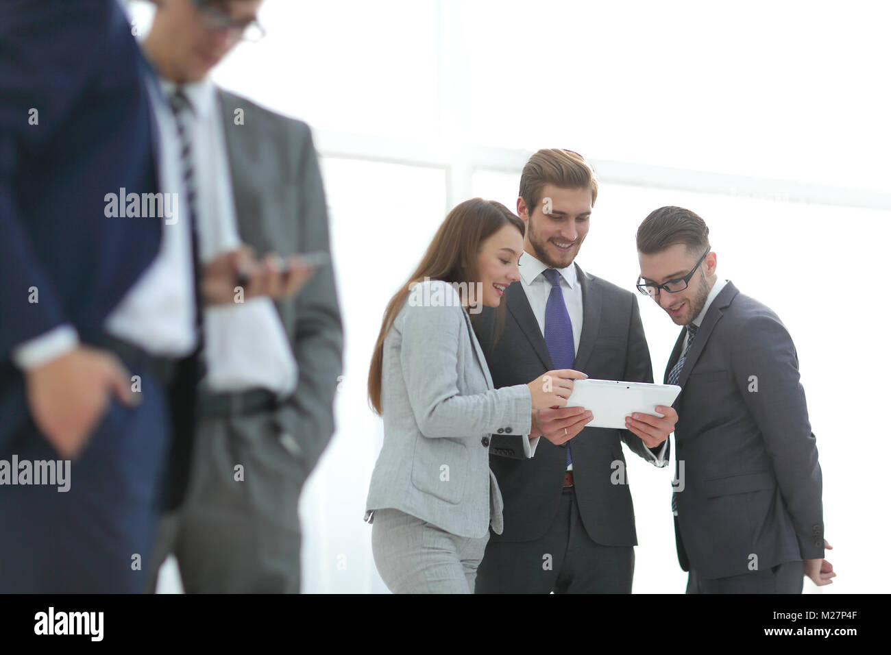 Business people are using gadgets and smiling while working Stock Photo ...