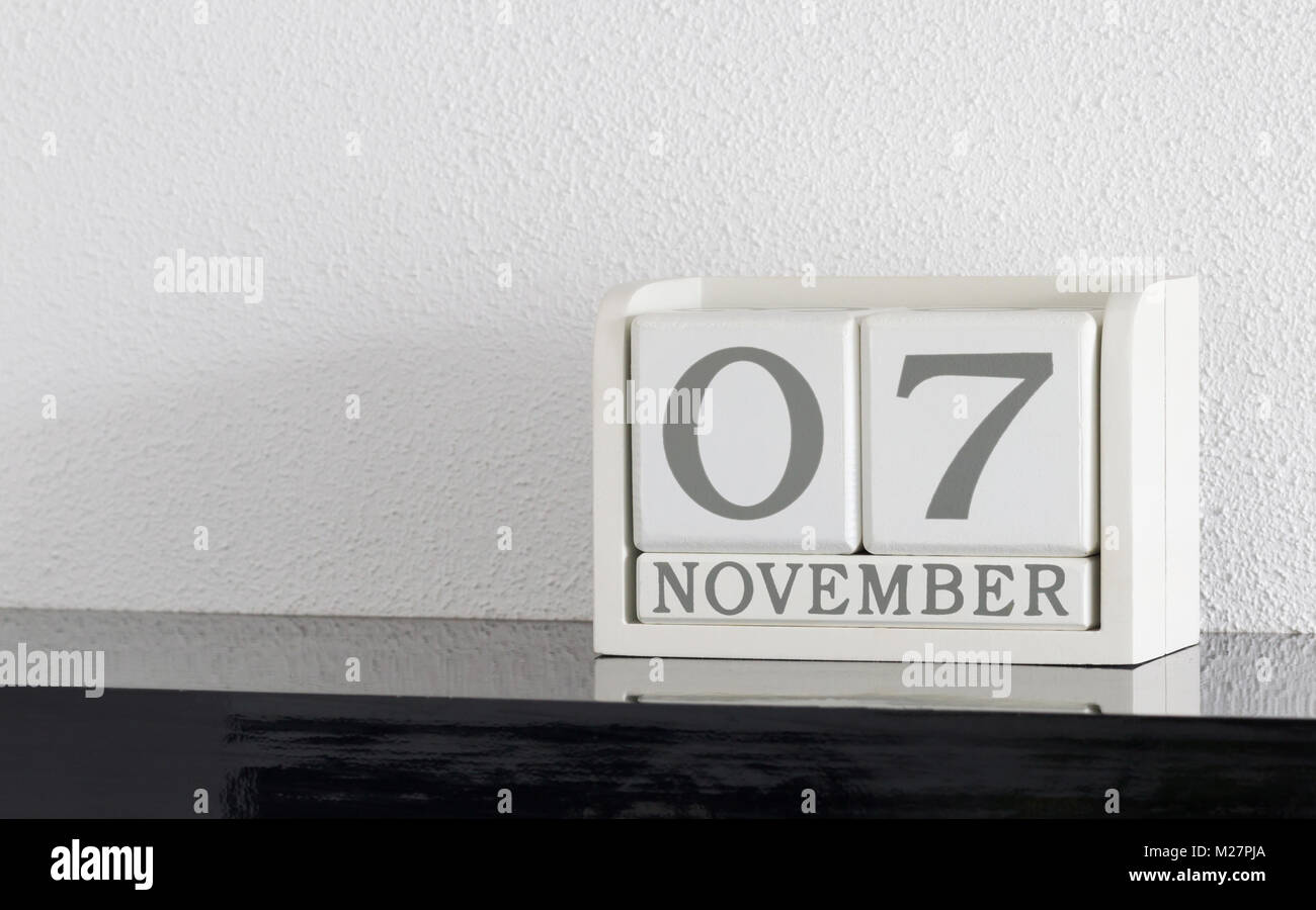 White block calendar present date 7 and month November on white wall ...