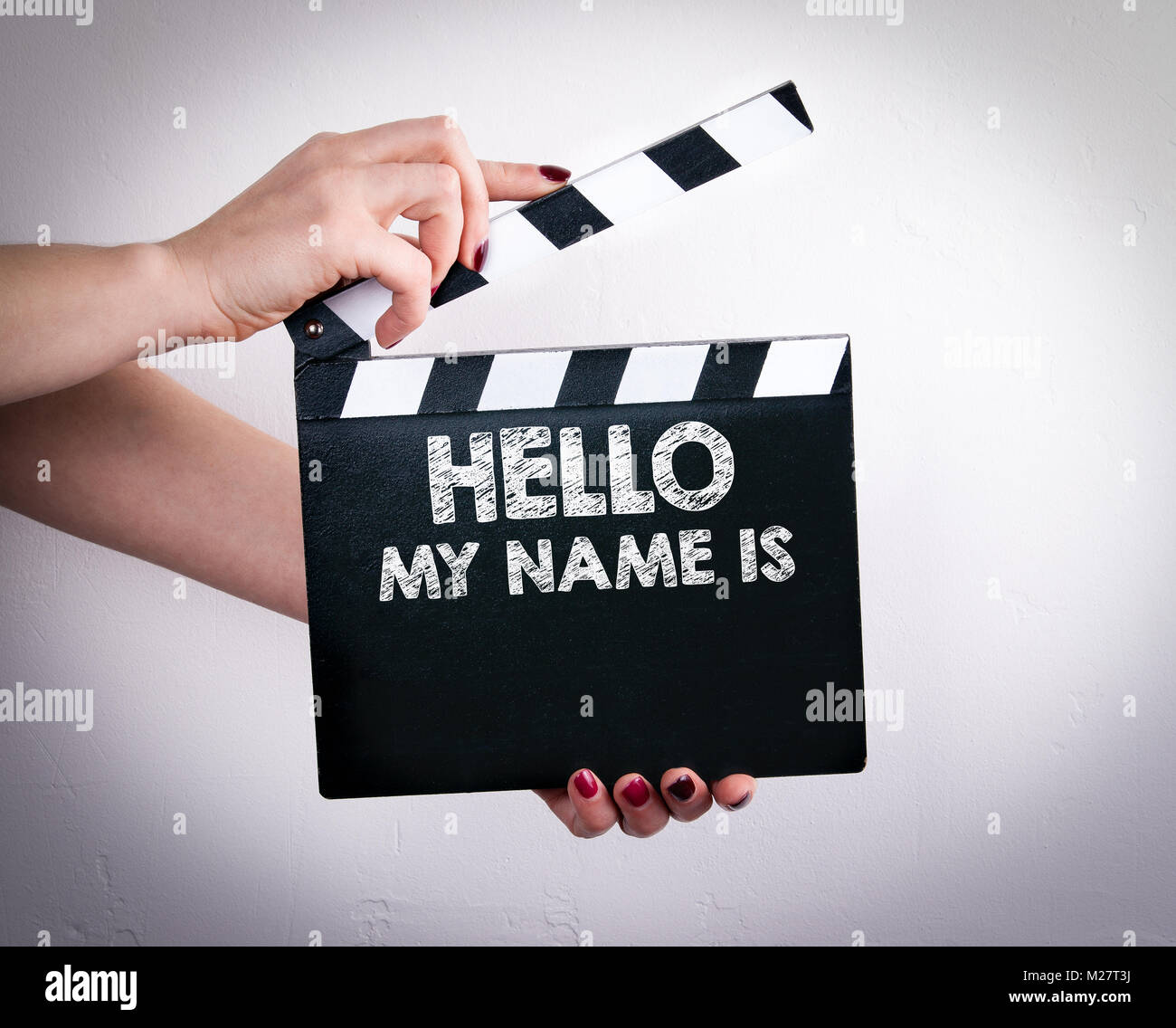 Hello My Name Is. Female hands holding movie clapper Stock Photo - Alamy
