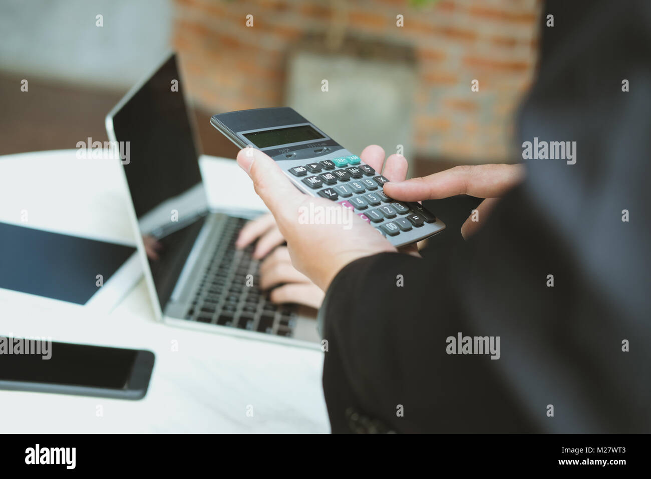 financial adviser working with calculator, business document & computer ...