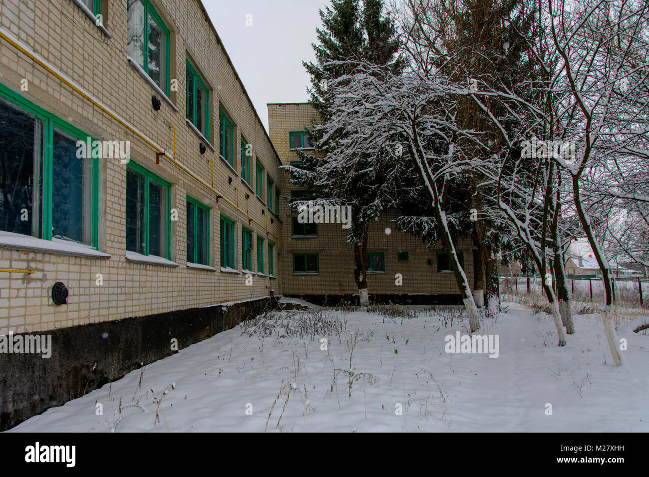 The facade of the destroyed and abandoned bakery building against the ...