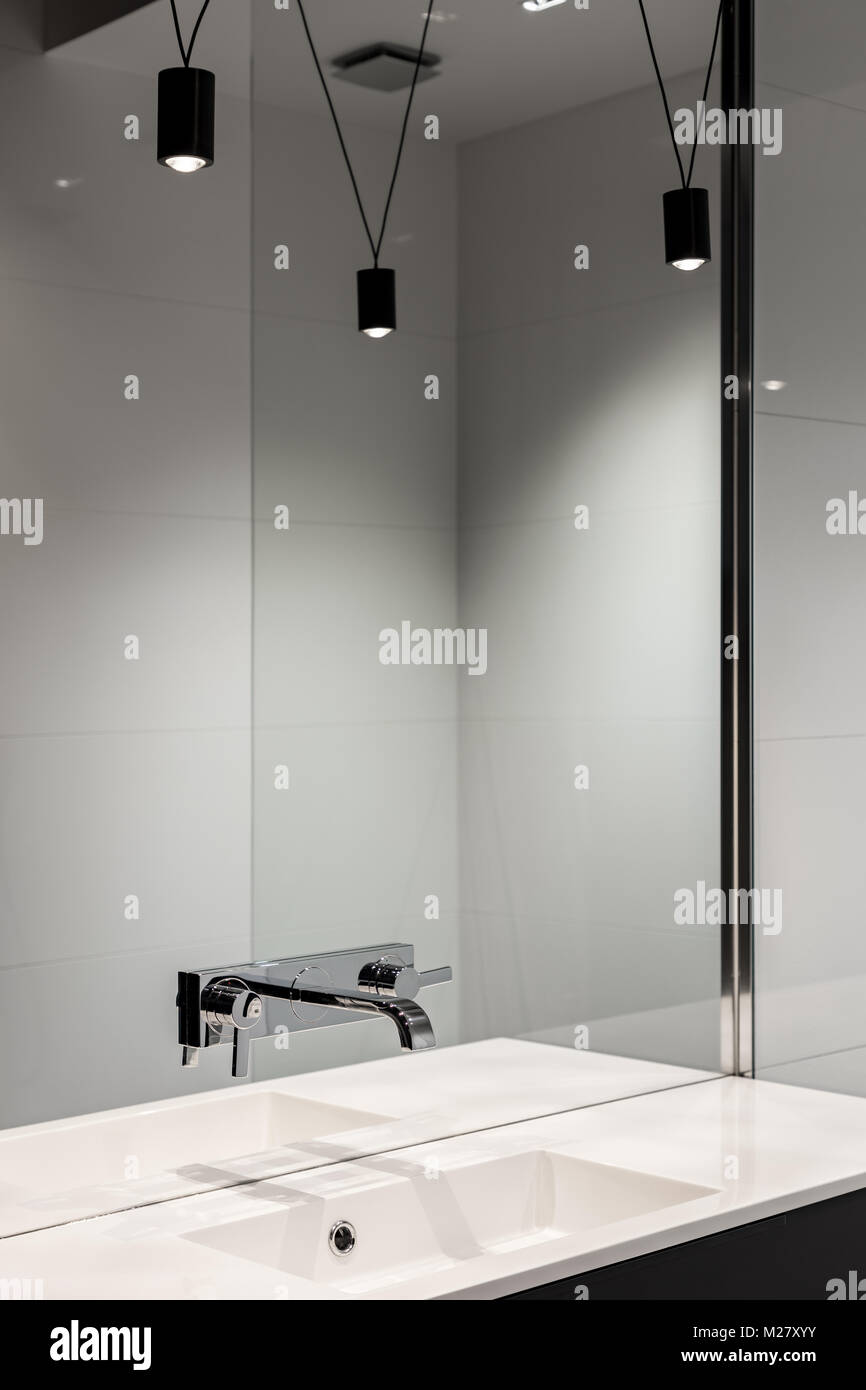 Chrome tap mounted in mirror wall in contemporary black and white ...