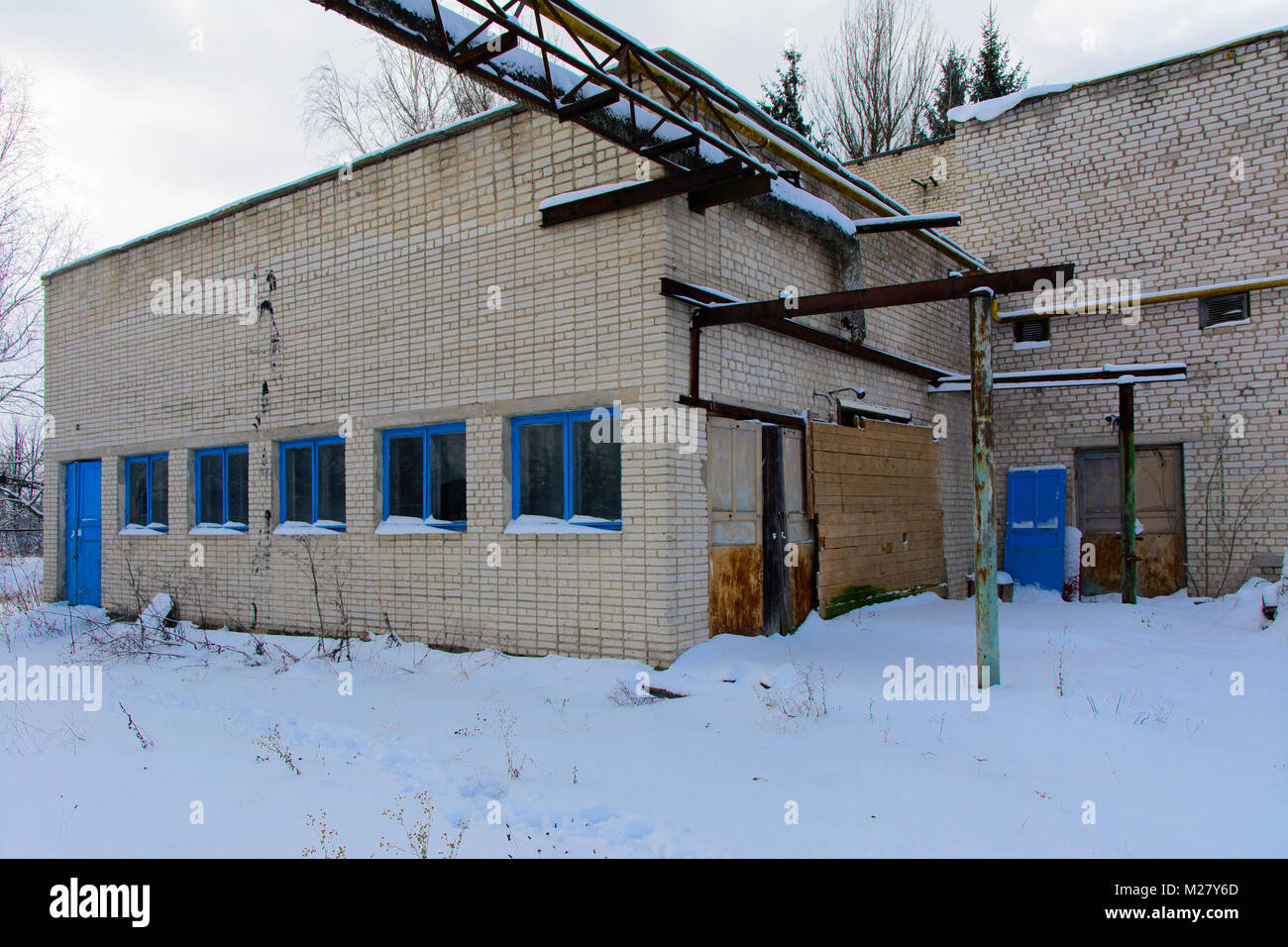 The facade of the destroyed and abandoned bakery building against the ...