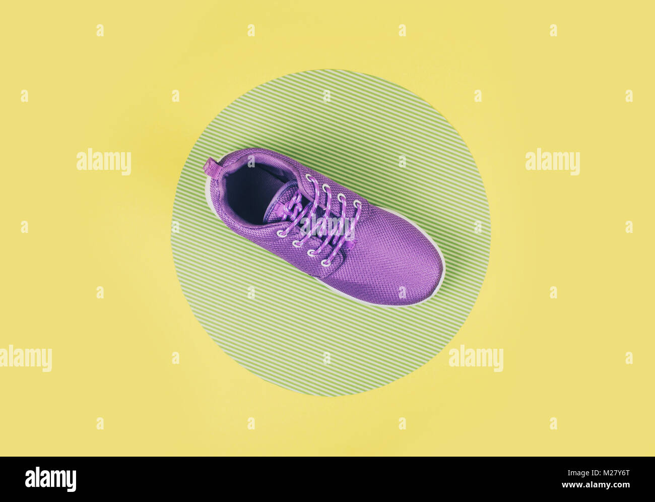 Lilac sneakers on a multi colored pastel surface Stock Photo - Alamy