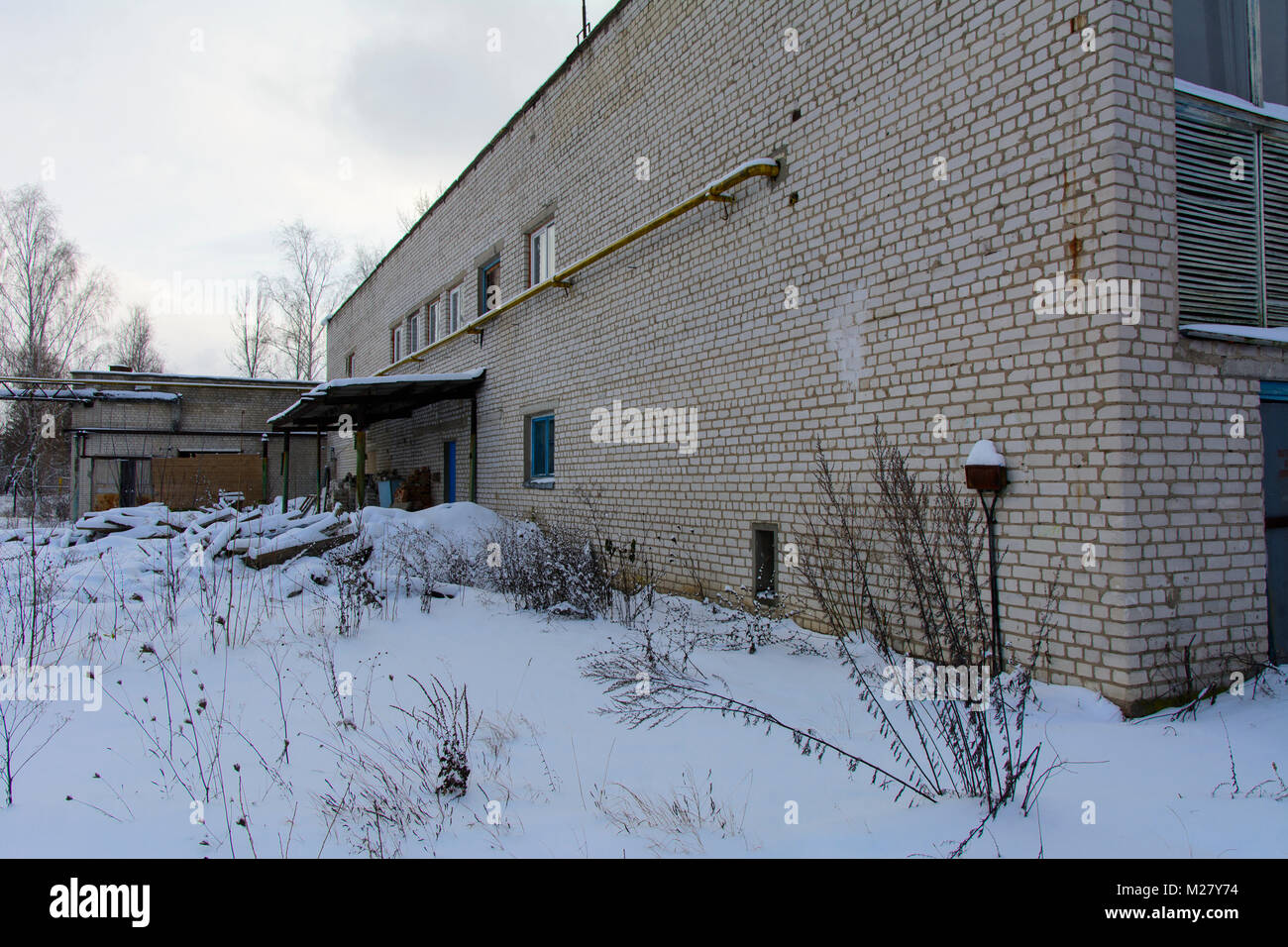 The facade of the destroyed and abandoned bakery building against the ...