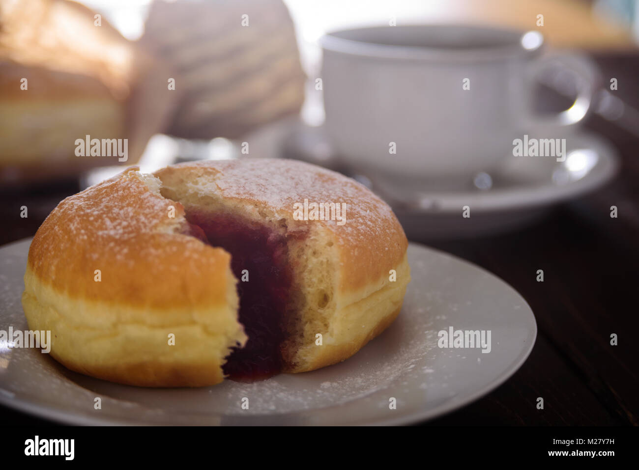 Berliner donut filled with strawberry jam. Close up Stock Photo - Alamy