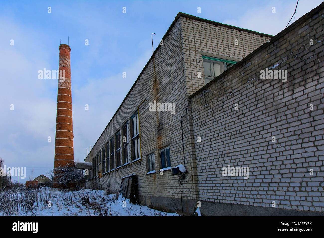 The facade of the destroyed and abandoned bakery building against the ...