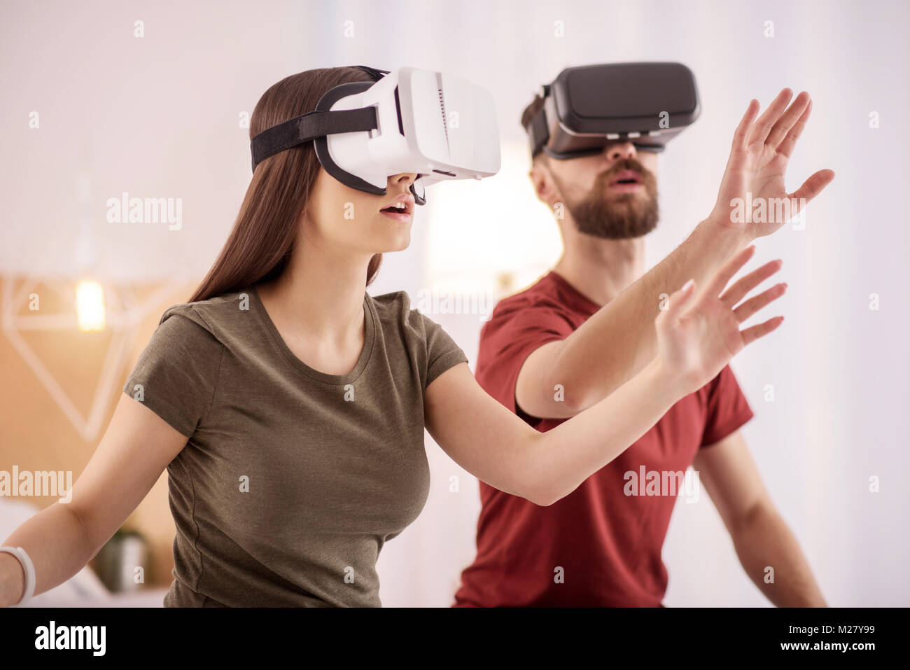 Enthusiastic appealing couple connecting to VR Stock Photo - Alamy
