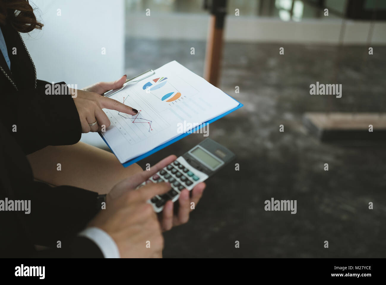 business adviser working with calculator & financial plan report at ...