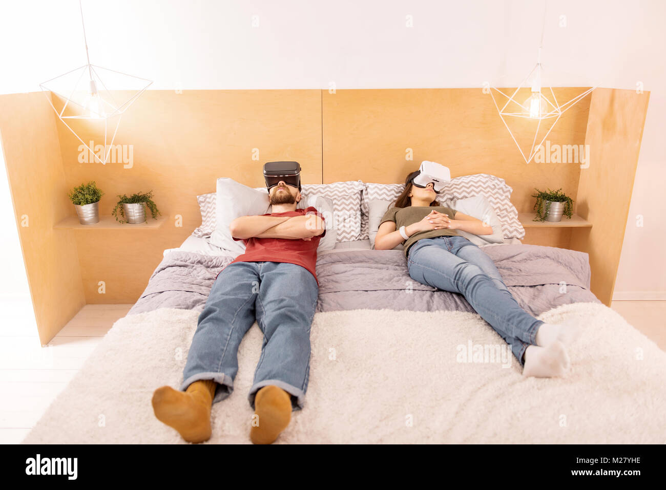 Tranquil couple watching detective in VR Stock Photo - Alamy