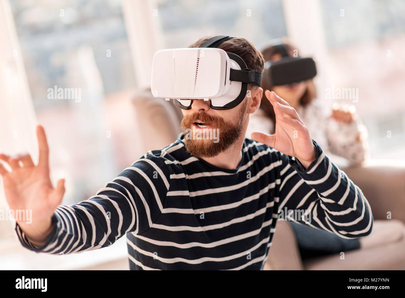 Earnest focused man fighting in VR Stock Photo - Alamy