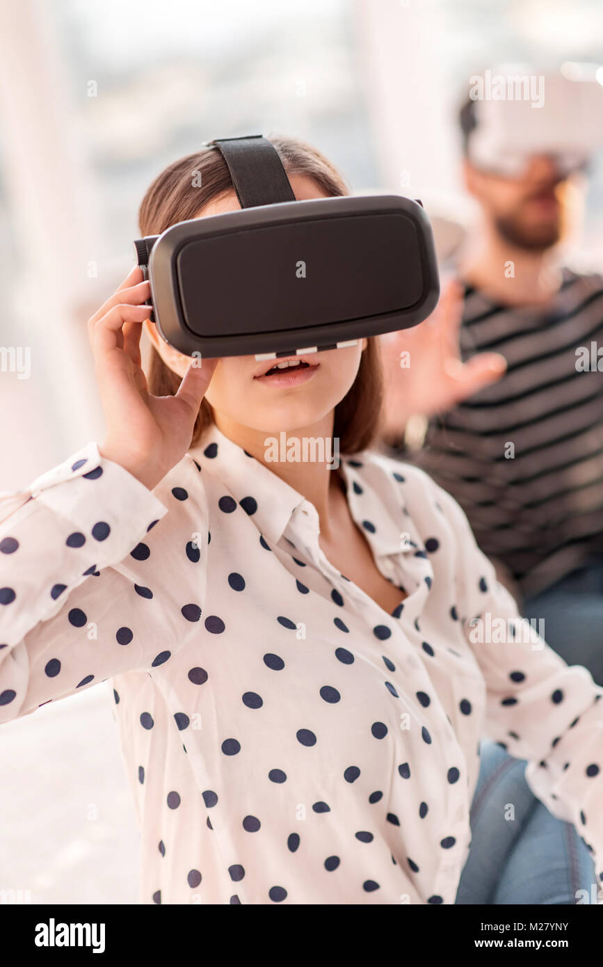 Pretty energetic woman powering VR glasses Stock Photo - Alamy