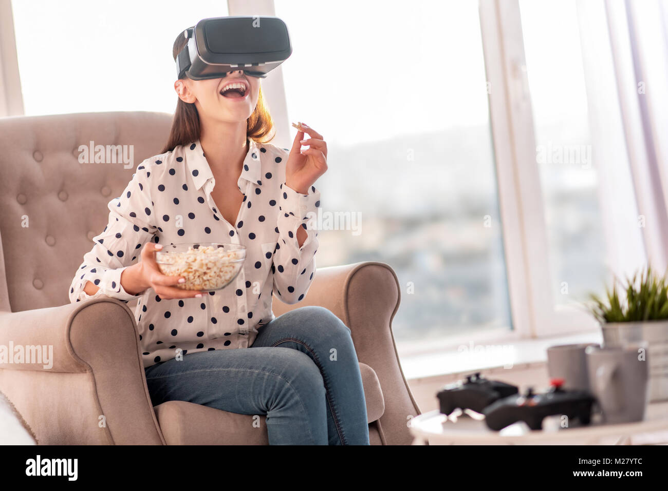 Vigorous energetic woman nickering during VR movie Stock Photo - Alamy