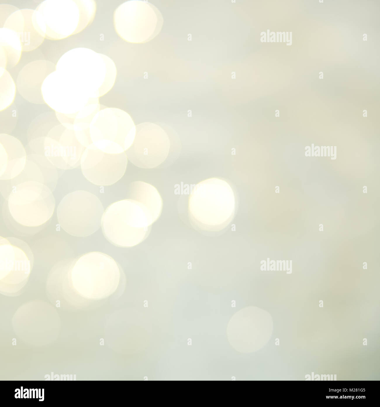 Soft focus bokeh light effects over a rippled, blue water background in ...