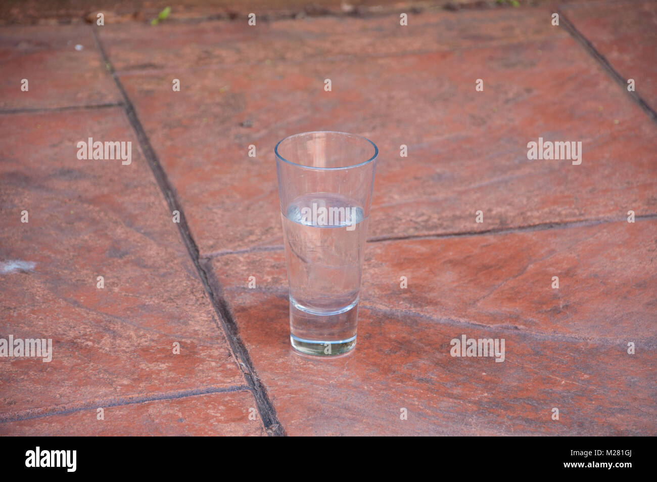 Glass Of Water On The Ground Stock Photo - Alamy