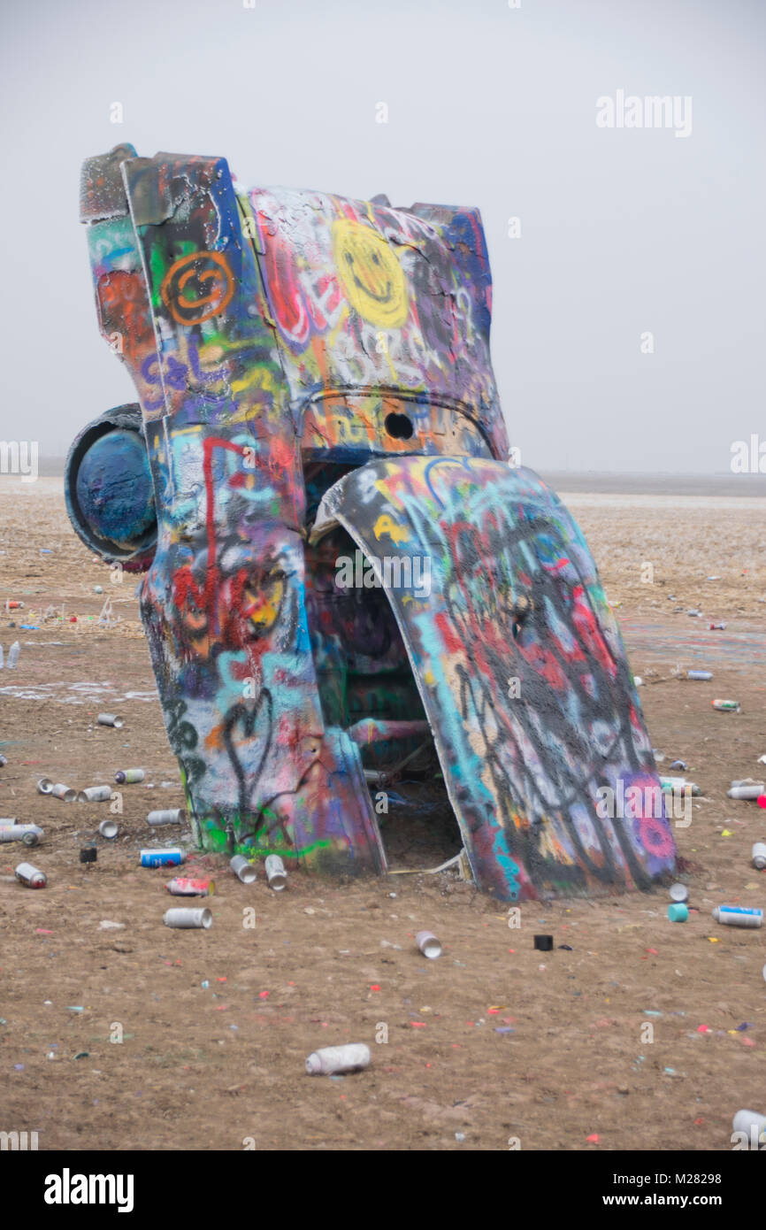 A cadillac covered in graffiti at Cadillac Ranch in Amarillo, Texas off ...