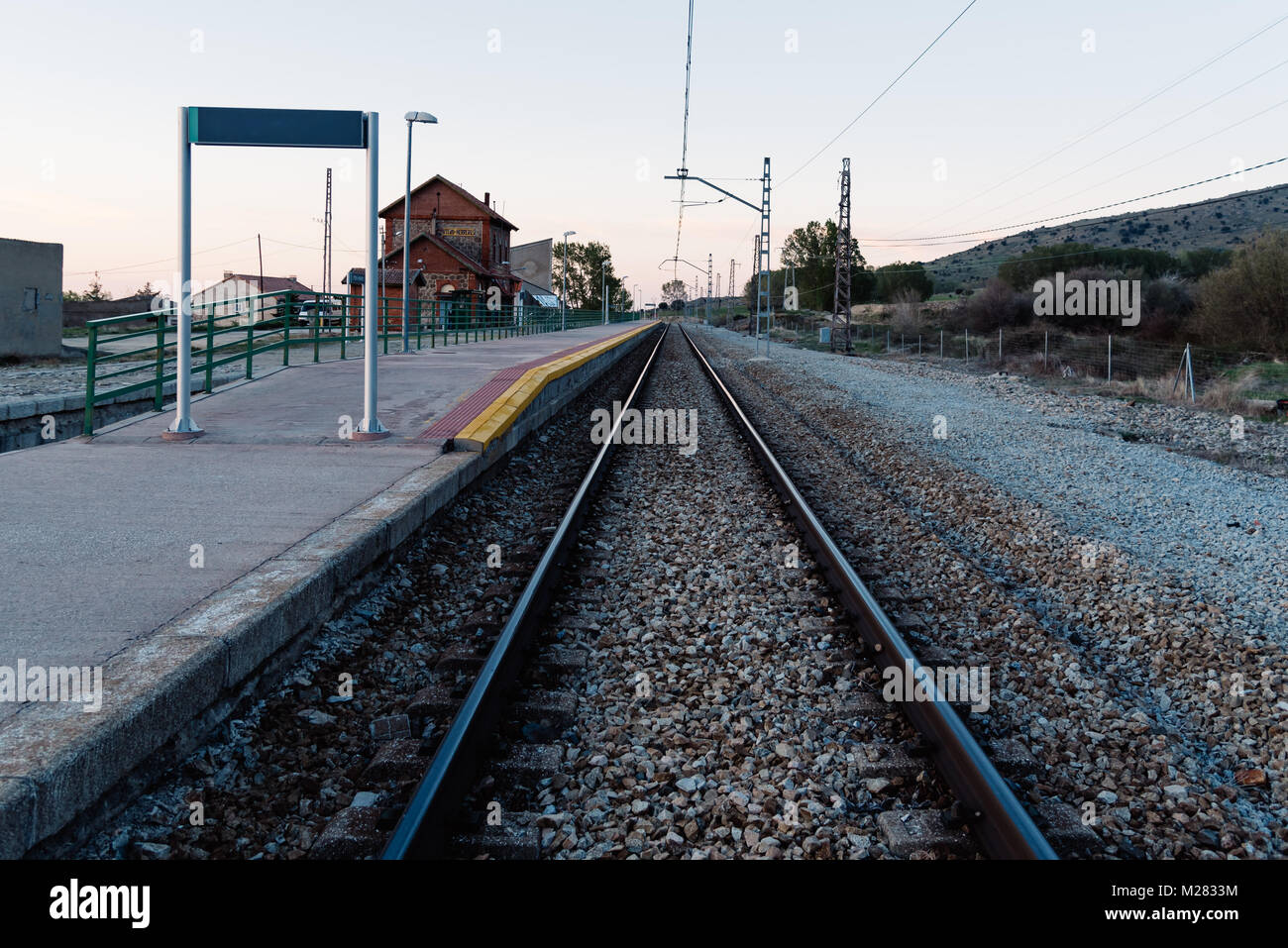Railroad tracks and old railroad station platform in countryside Stock ...