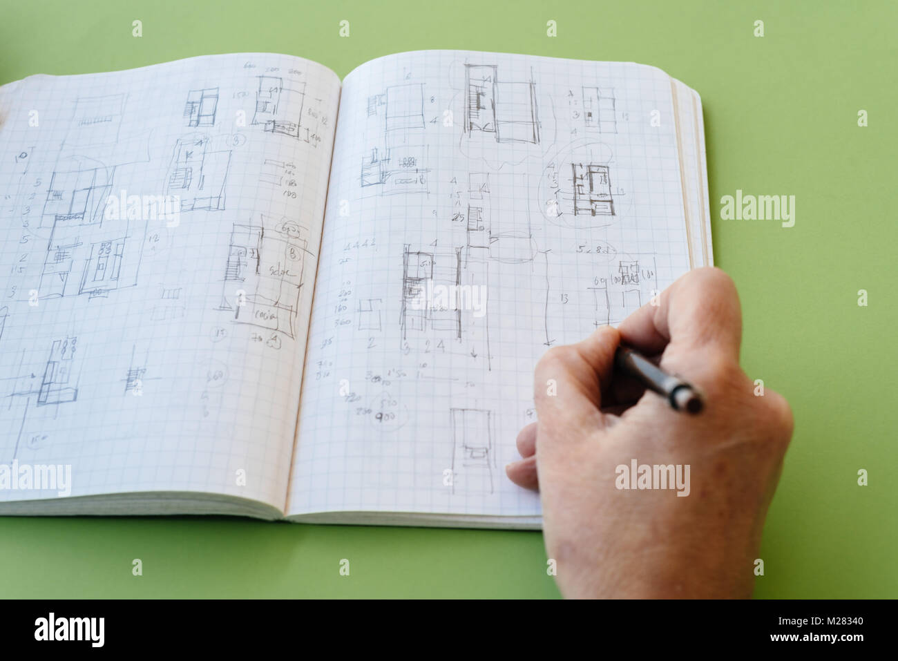 Architect works drawing sketches on notebook on green background Stock ...