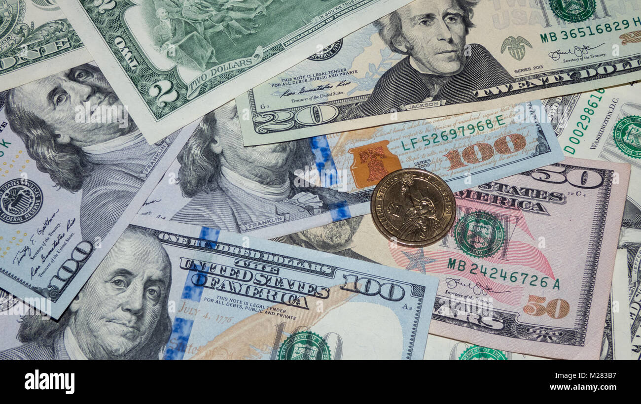 background from the heap of American dollars and a one-dollar coin, top ...