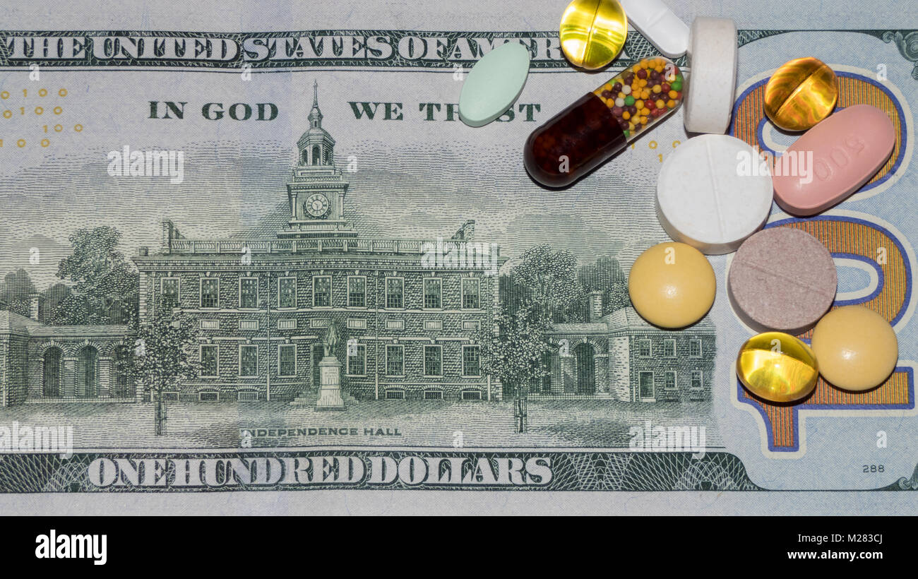 colorful pills and capsules on the hundred dollar bill, top view Stock ...